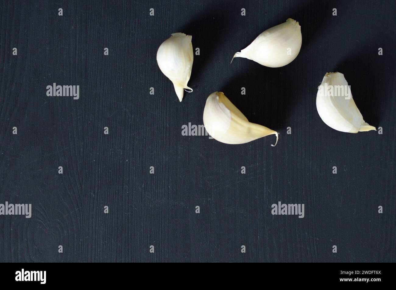 White garlic photography on black background Stock Photo - Alamy