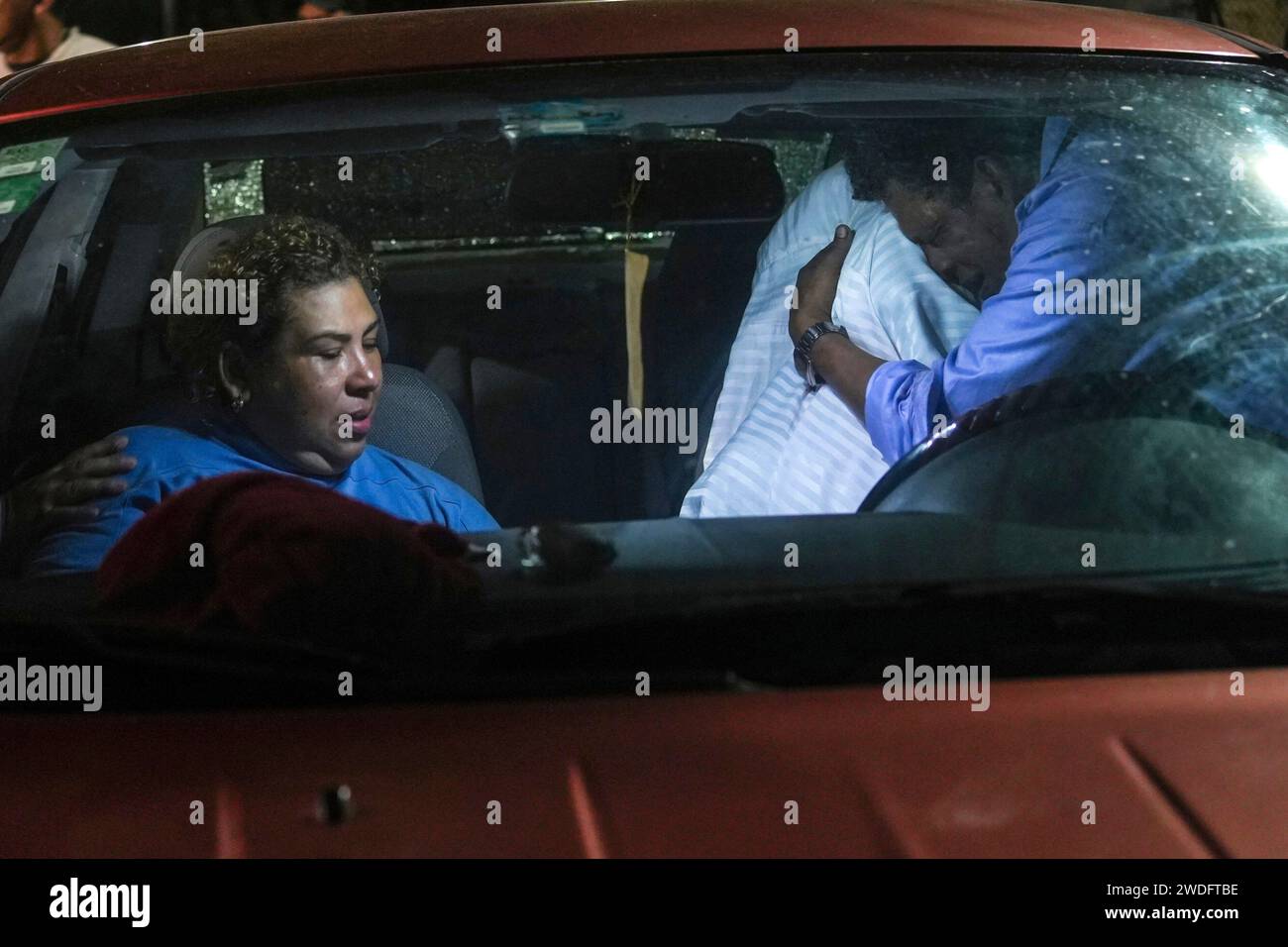 Erika Maria Cruz, left, grieves as her husband Delfino Arellano ...