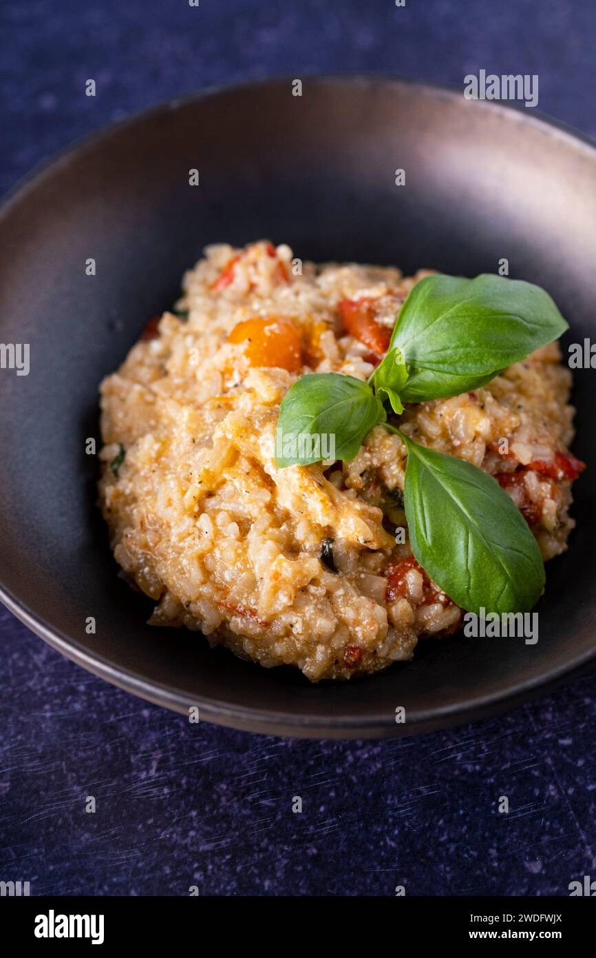 Tomato risotto with basil, ricotta and parmesan Stock Photo - Alamy