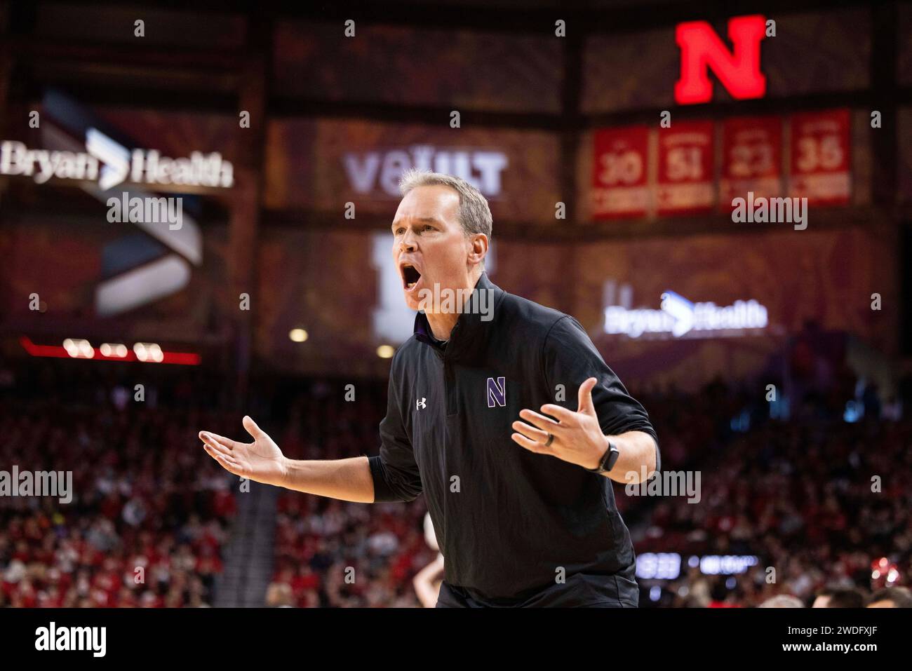 Northwestern head coach Chris Collins protests a referee's call while ...