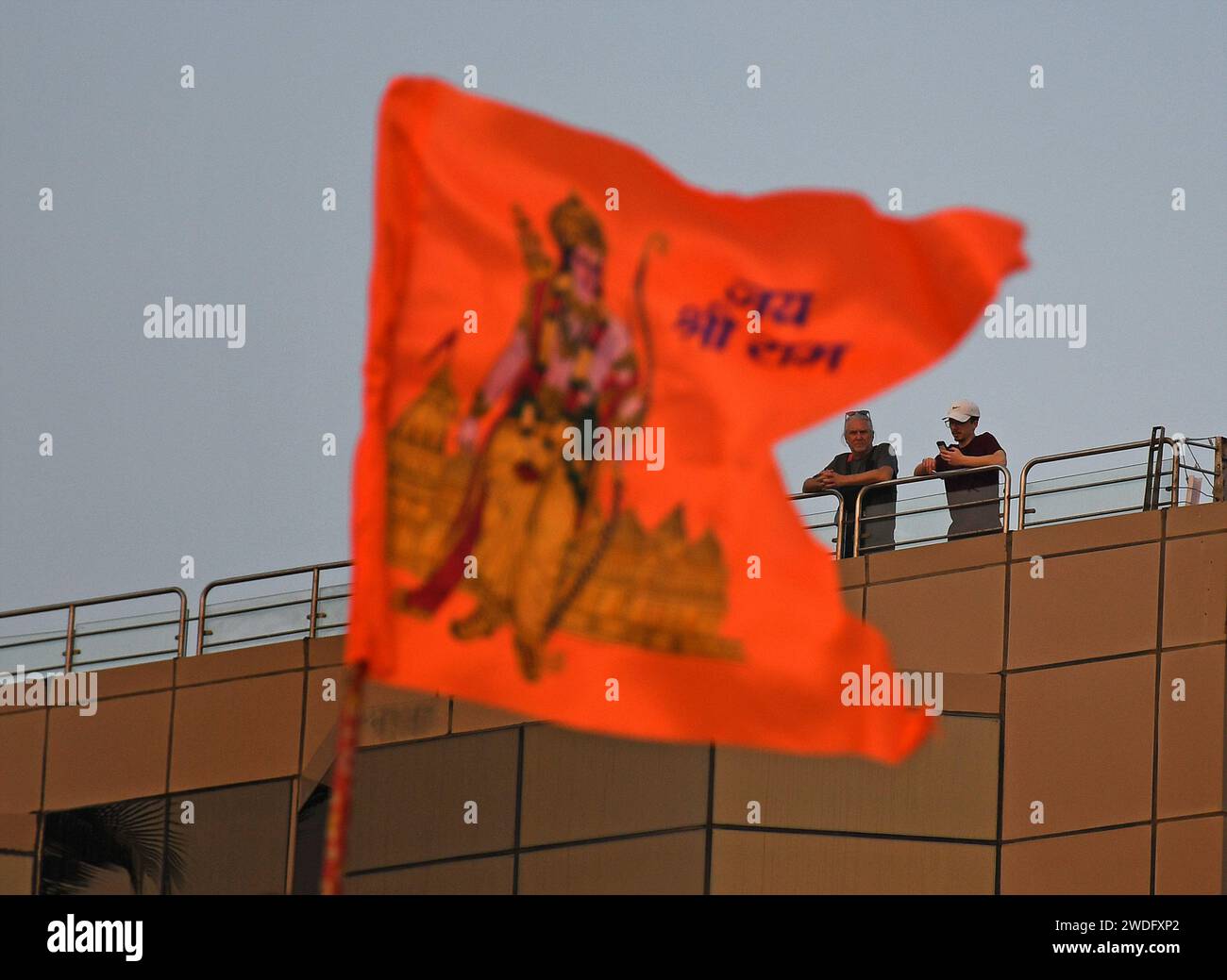 Foreigners are seen standing on the roof of a hotel behind the flag of ...