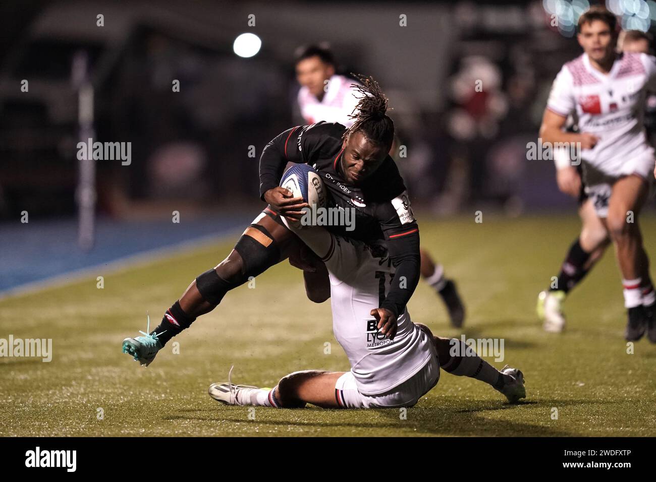 Saracens' Rotimi Segun is tackled by Lyon's Alexandre Tchaptchet during ...