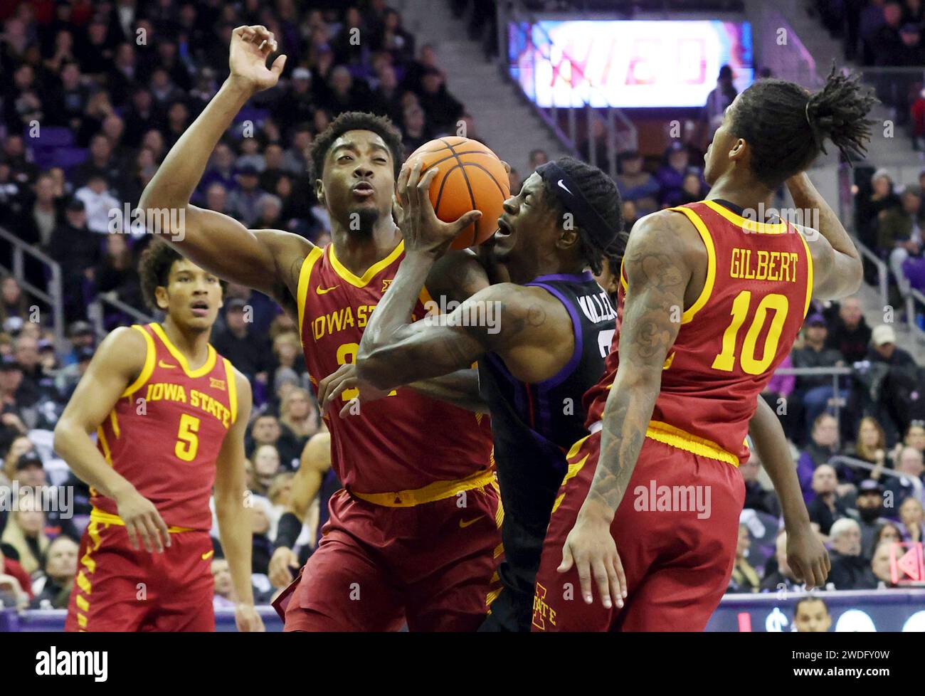 TCU forward Emanuel Miller (2) tries to shoot between Iowa State guard ...