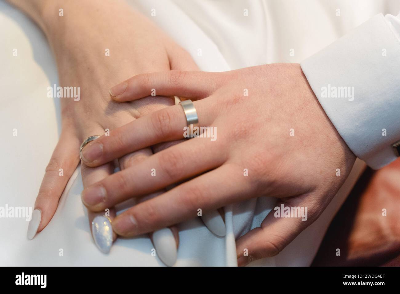 Augsburg, Bavaria, Germany - January 19, 2024: Hands with rings of a ...