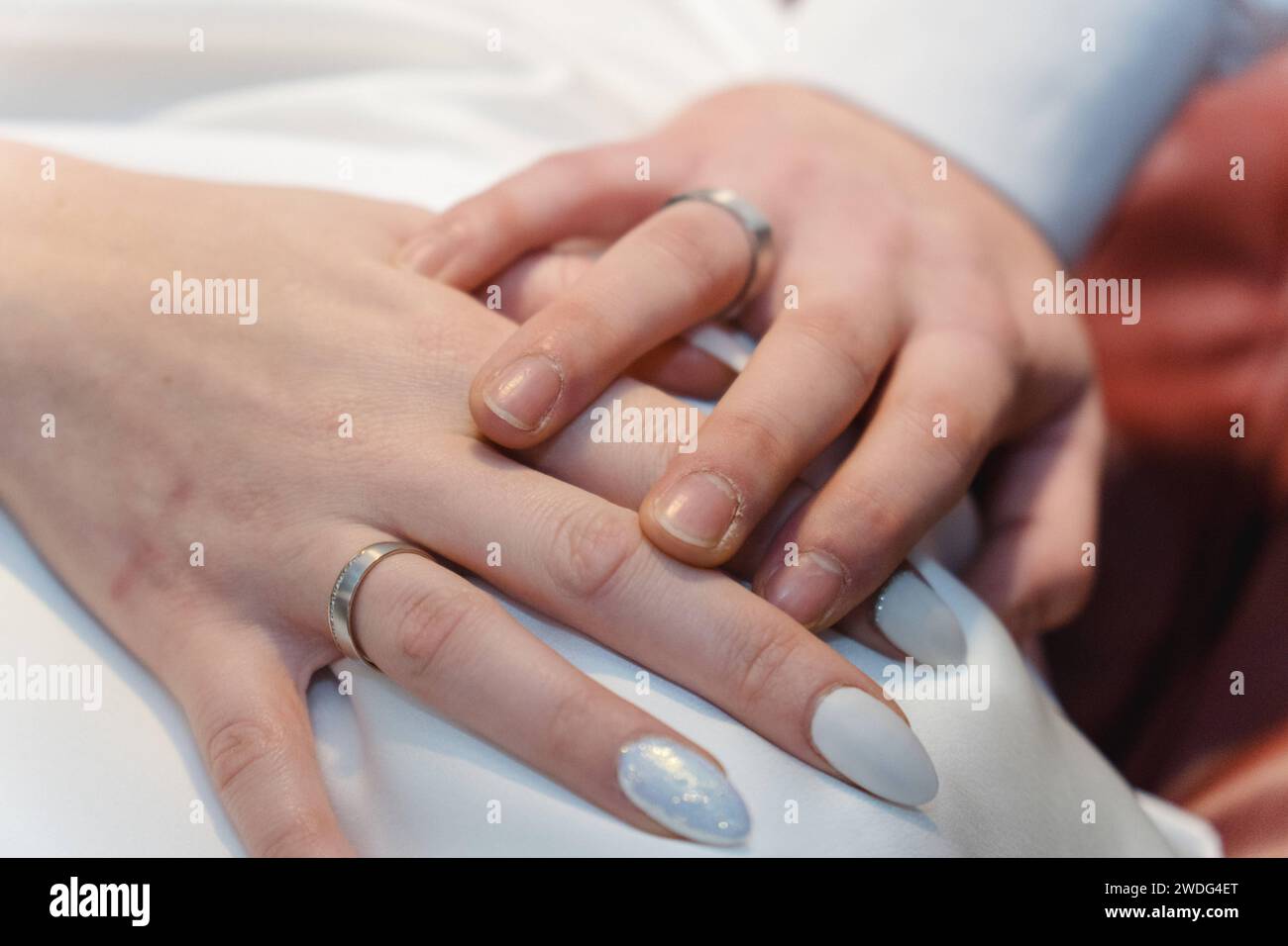 Augsburg, Bavaria, Germany - January 19, 2024: Hands with rings of a ...