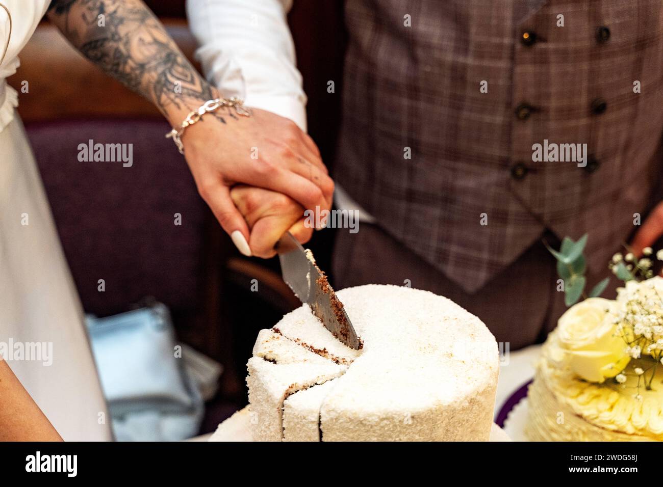 Augsburg, Bavaria, Germany - January 19, 2024: A bride and groom cut a ...