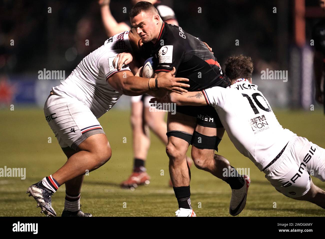 Saracens' Ben Earl is tackled by Lyon's Leo Berdeu (right) during the ...