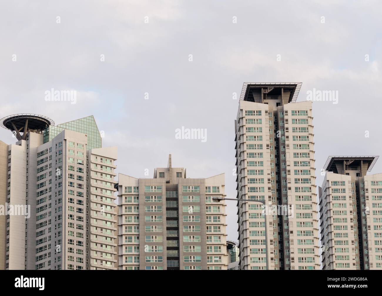 High-rise twin towers rising against a cloudy sky in Sintanjin, South ...