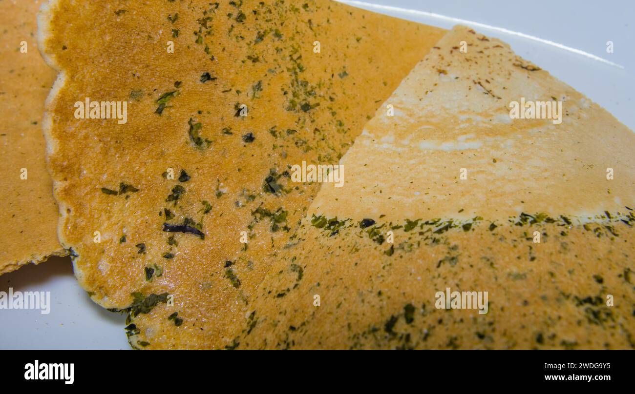 Closeup of crispy traditional Korean rice and seaweed cookies on white ...