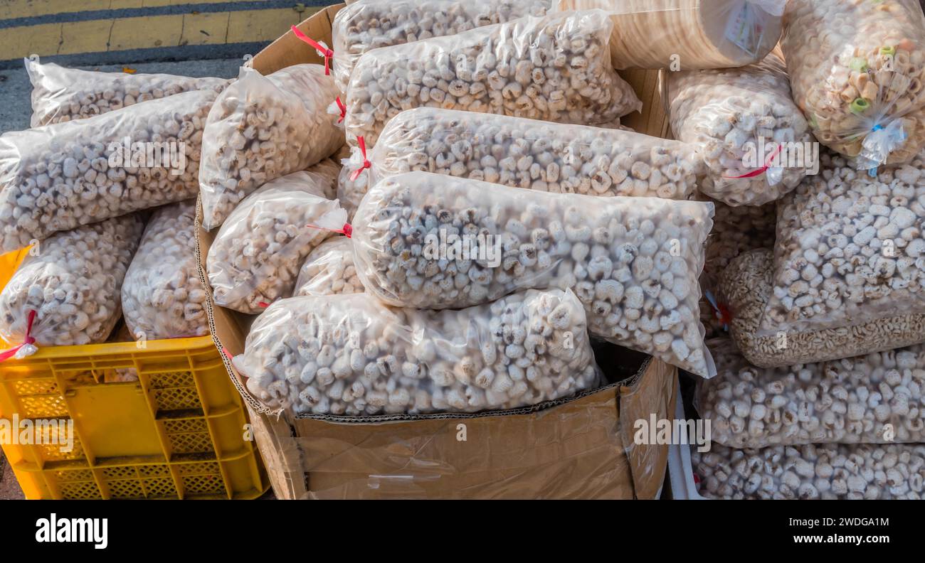 Bags of Korean puffed corn snacks in plastic and cardboard boxes on ...