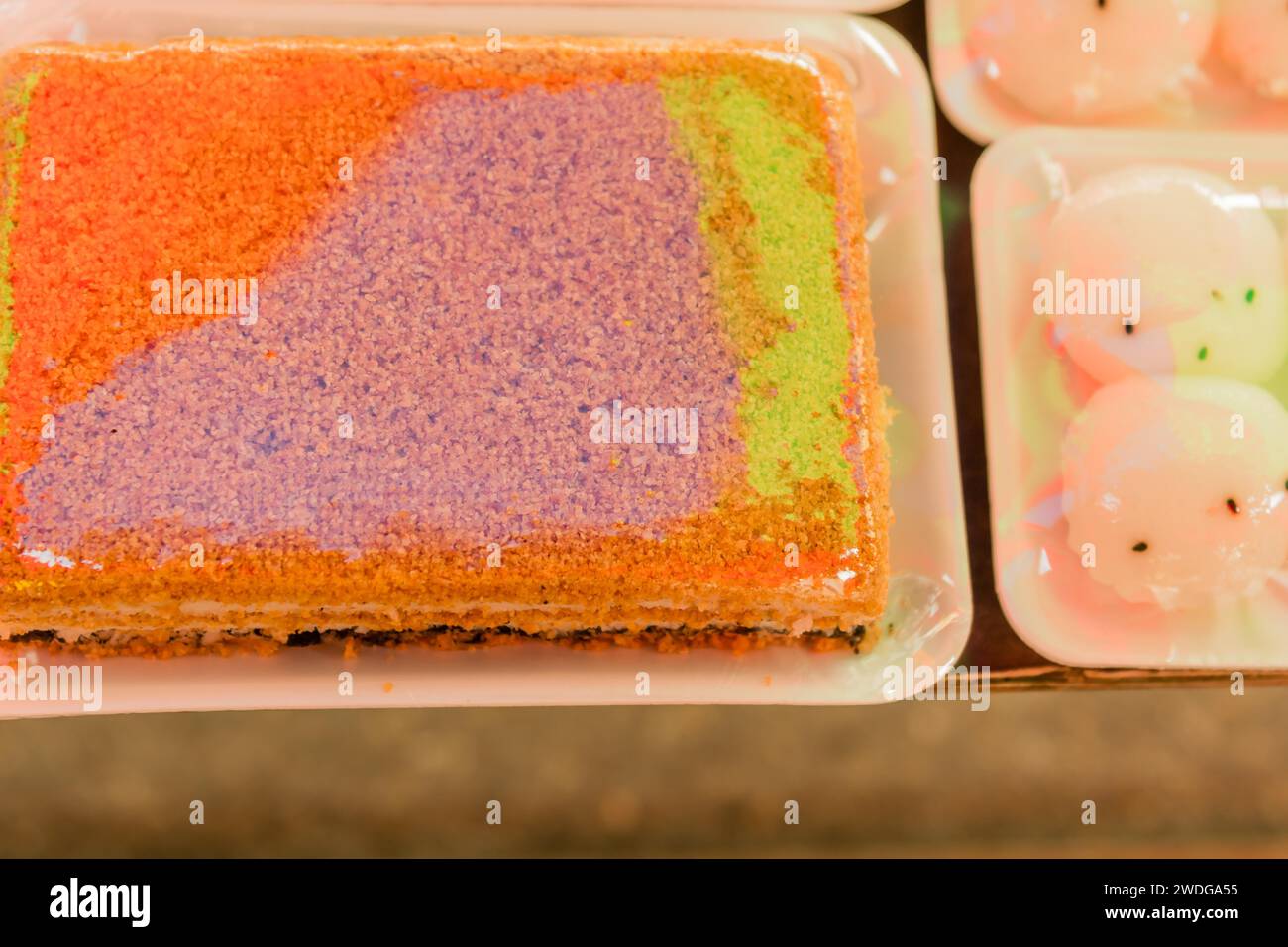 Closeup of colorful rice cake wrapped on Styrofoam plate for sale at ...
