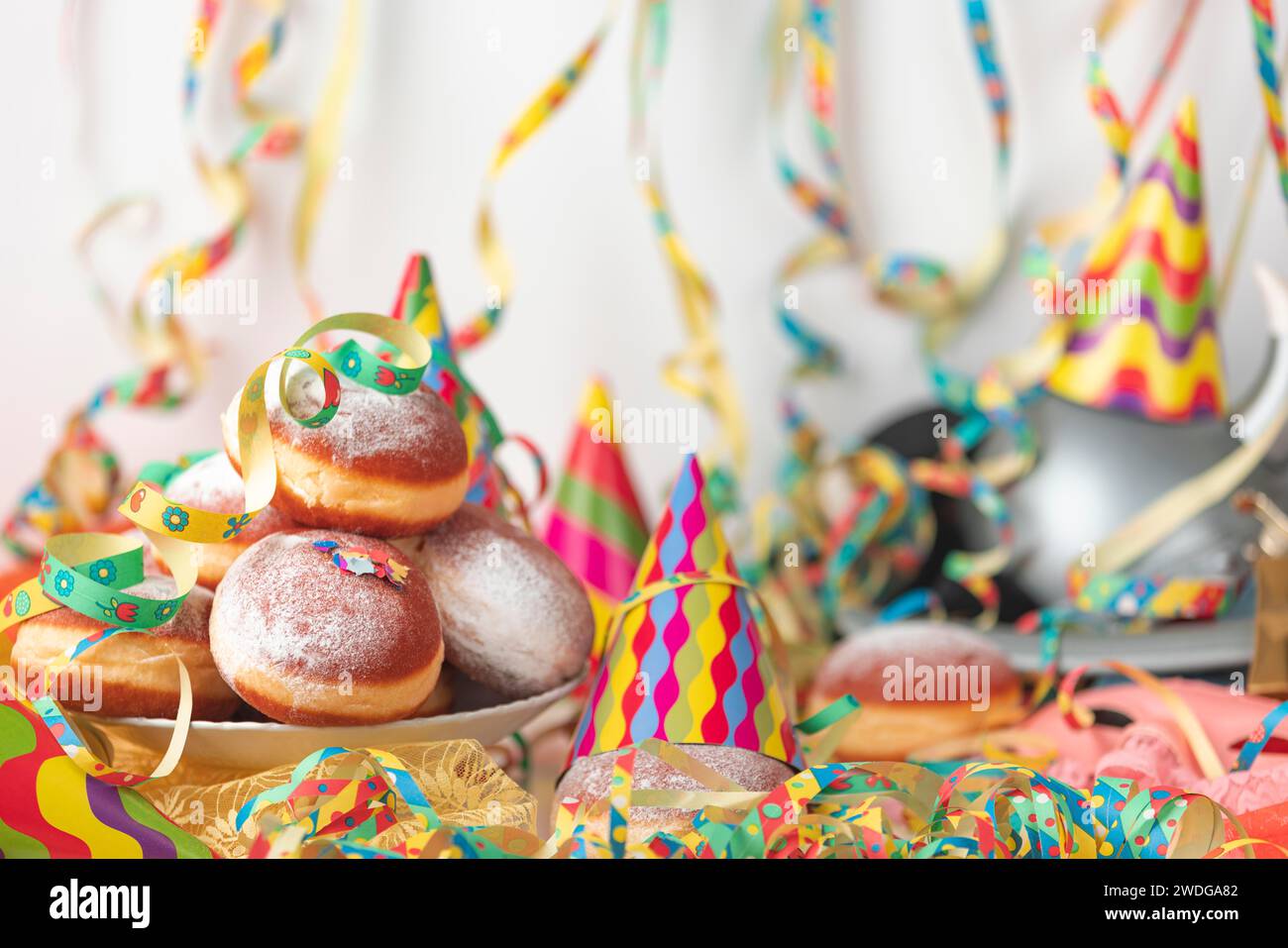Carnival atmosphere with party hats and doughnuts on a table Stock ...