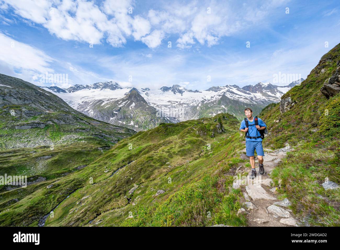 Mountaineer on hiking trail in picturesque mountain landscape, mountain ...
