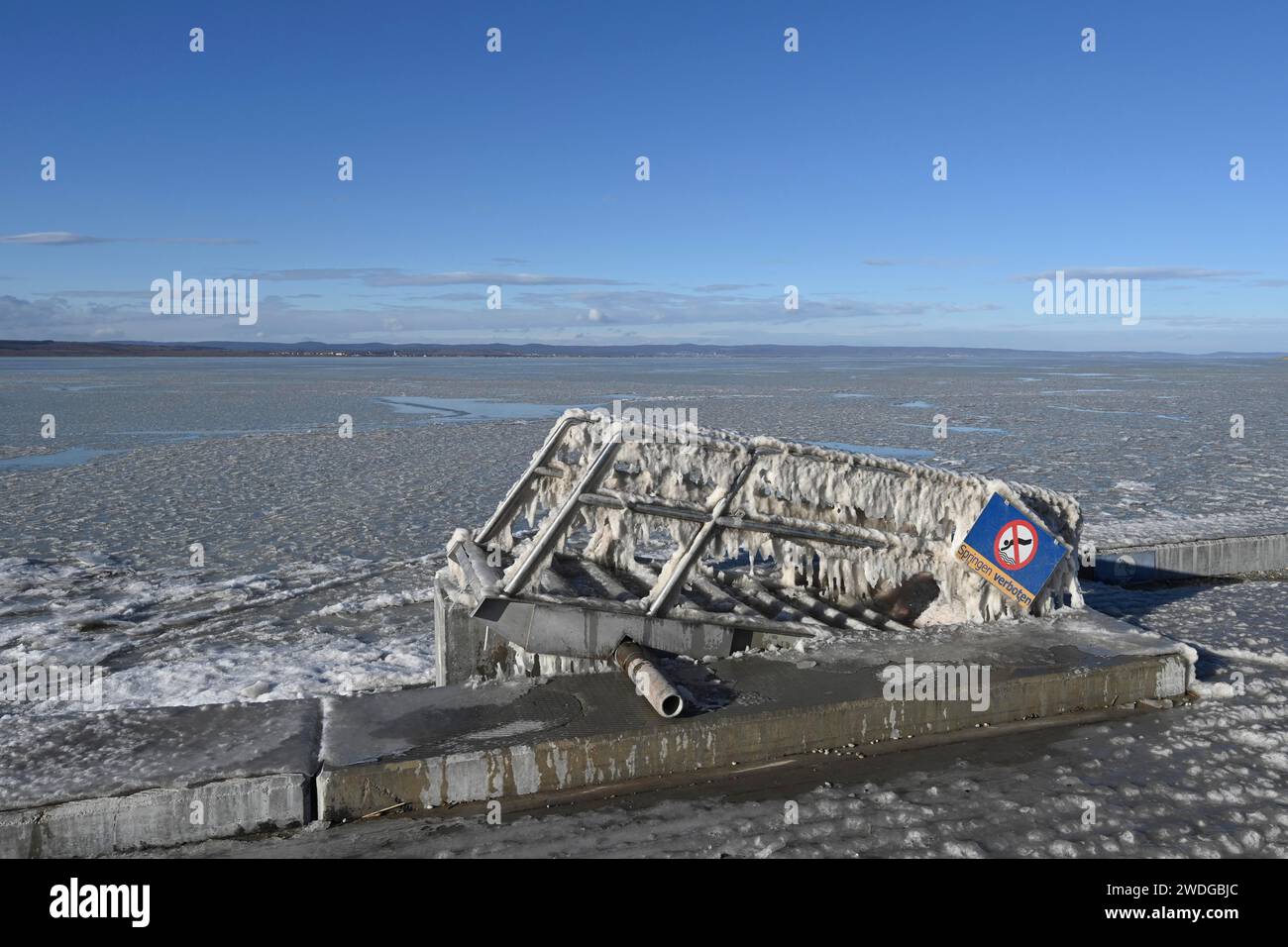 Frozen lake, ice and structures on iron ladder, Illmitz, Lake Neusiedl ...