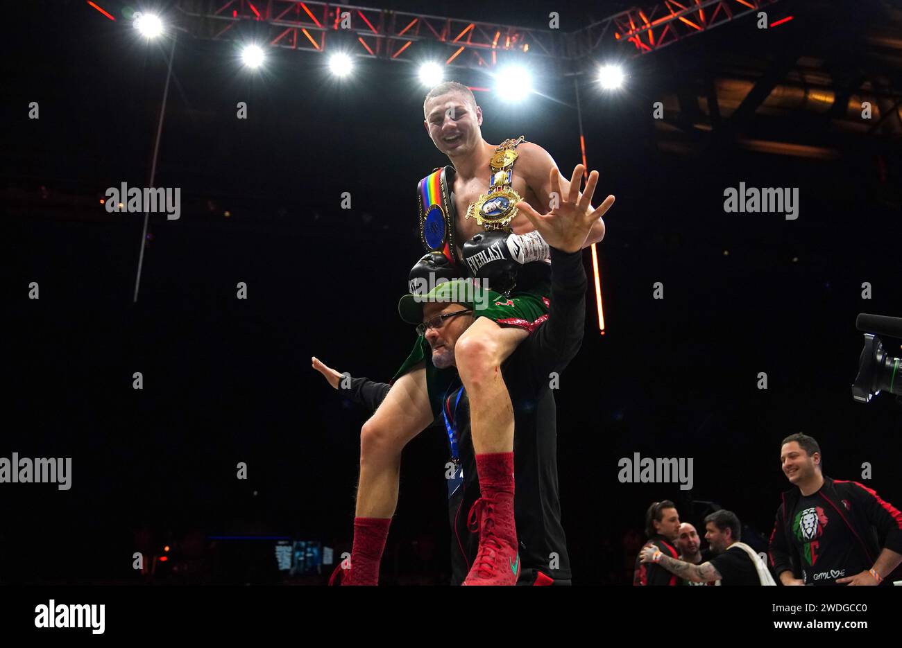 Zak Chelli is lifted up by a member of his team after victory against ...