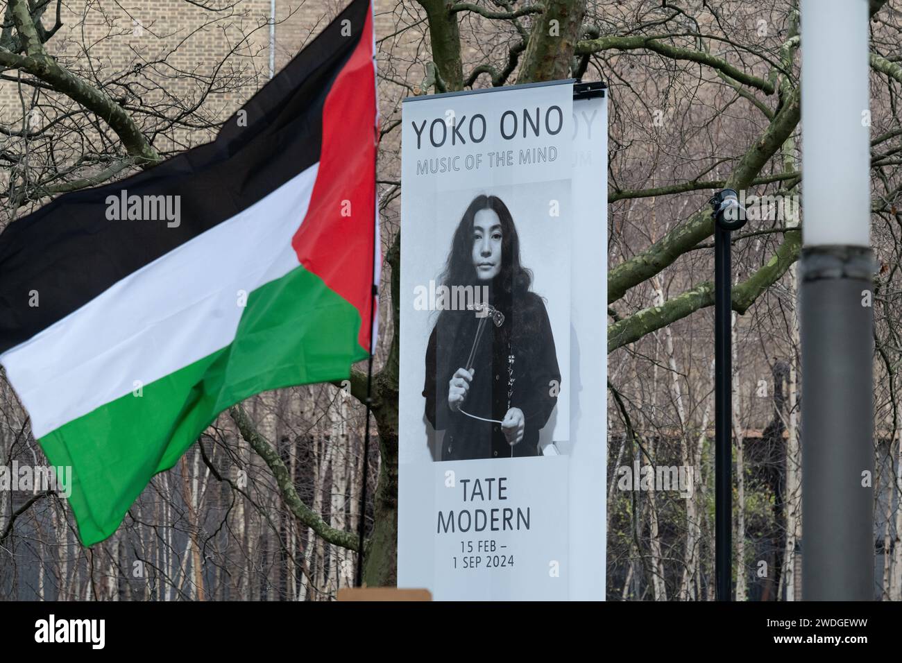 London, UK. 20 January, 2024. A Palestinian flag flies next to a poster advertising an ...