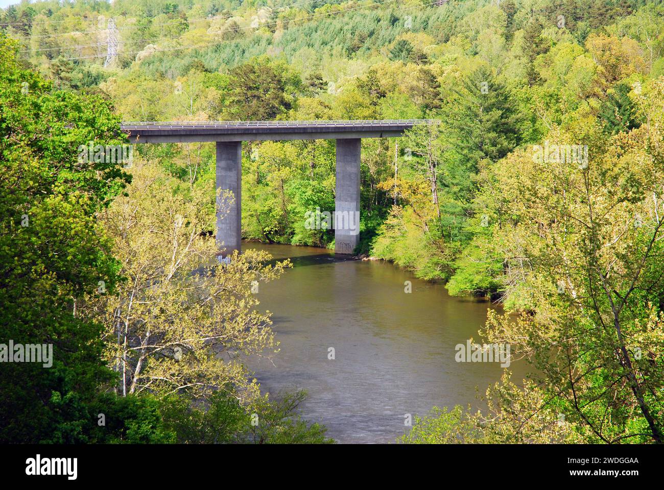 A bridge for the Blue Ridge Parkway carries traffic over a river and is ...