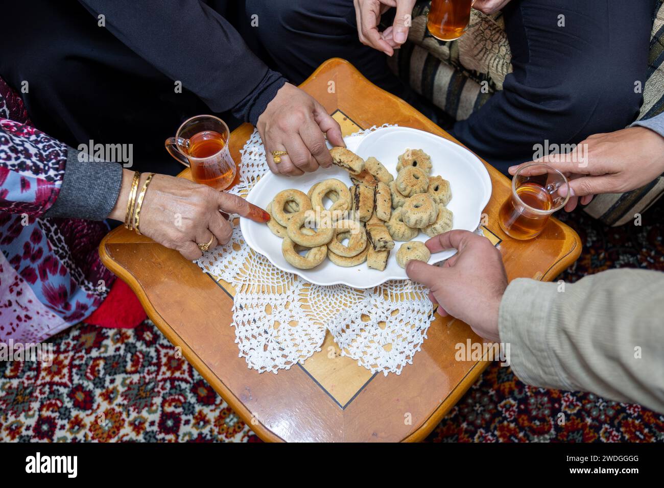 Enjoy eid sweets with warm tea cups Stock Photo - Alamy
