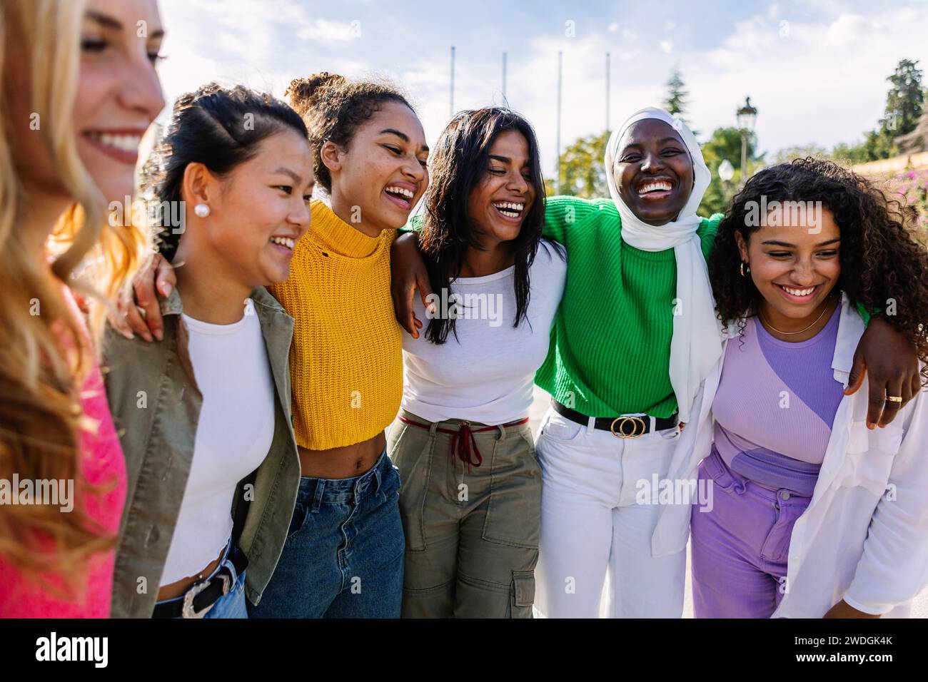 Happy young group of women laughing together outdoors Stock Photo - Alamy