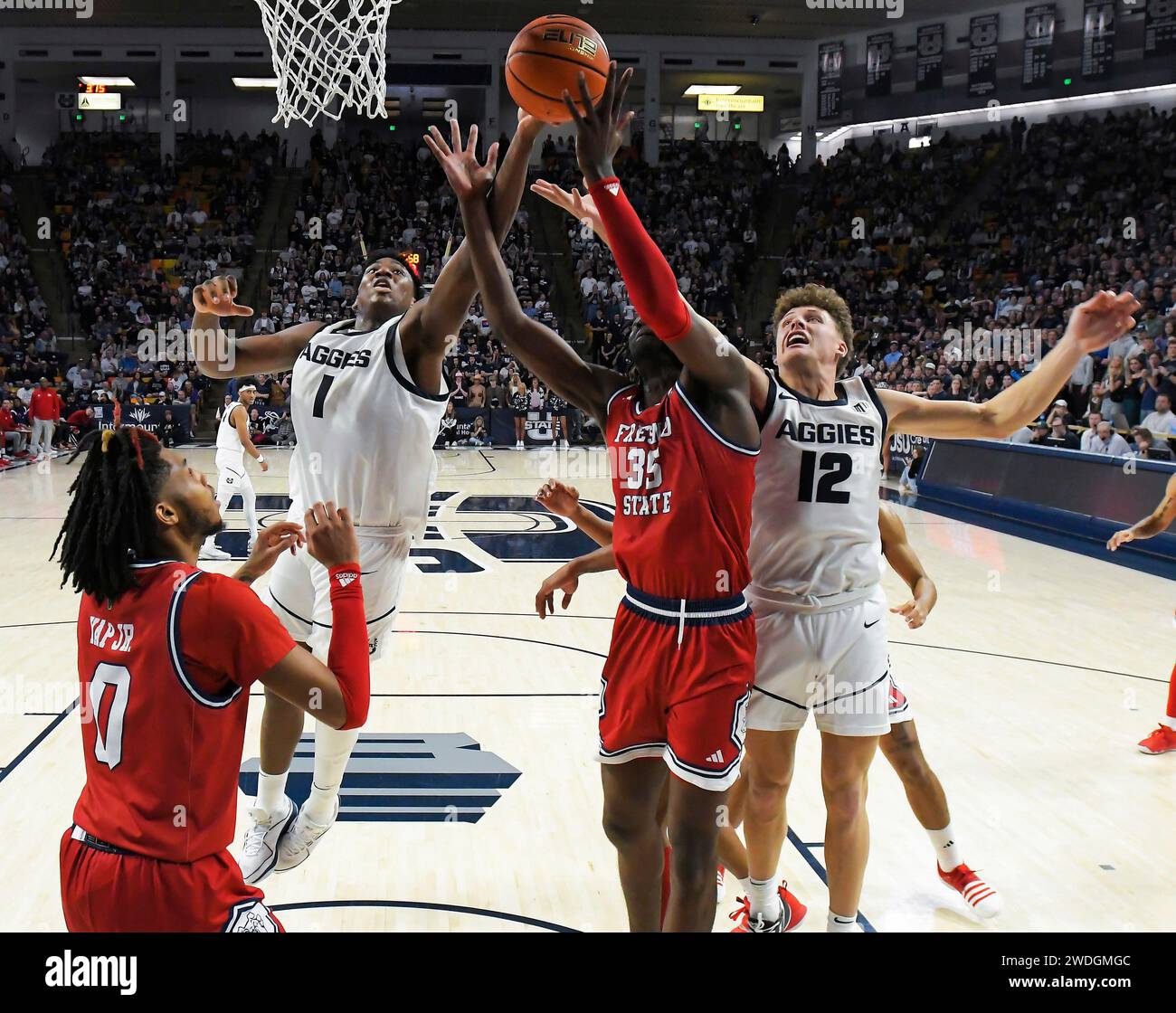 Utah State forward Great Osobor (1) and guard Mason Falslev (12) fight ...