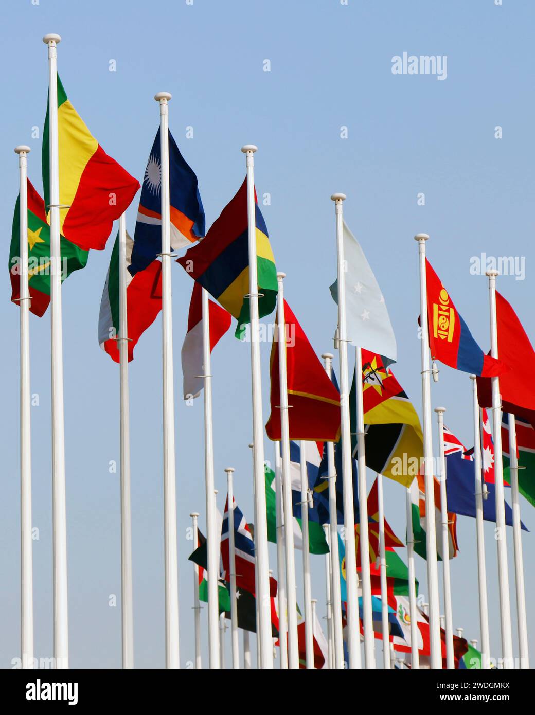Group of flags of many different nations against blue sky Stock Photo ...