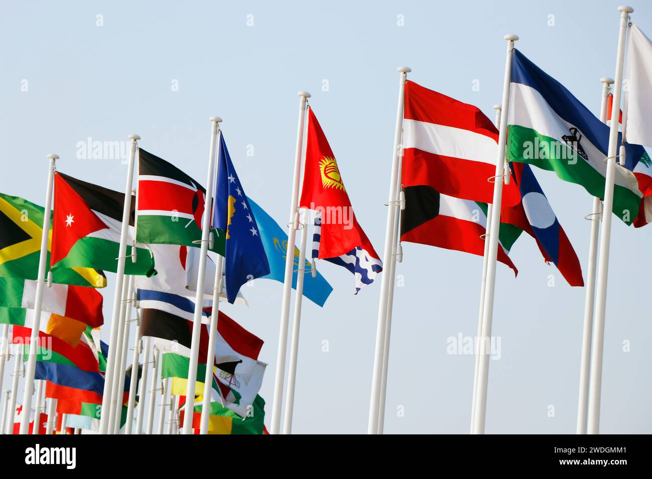 Group of flags of many different nations against blue sky Stock Photo ...