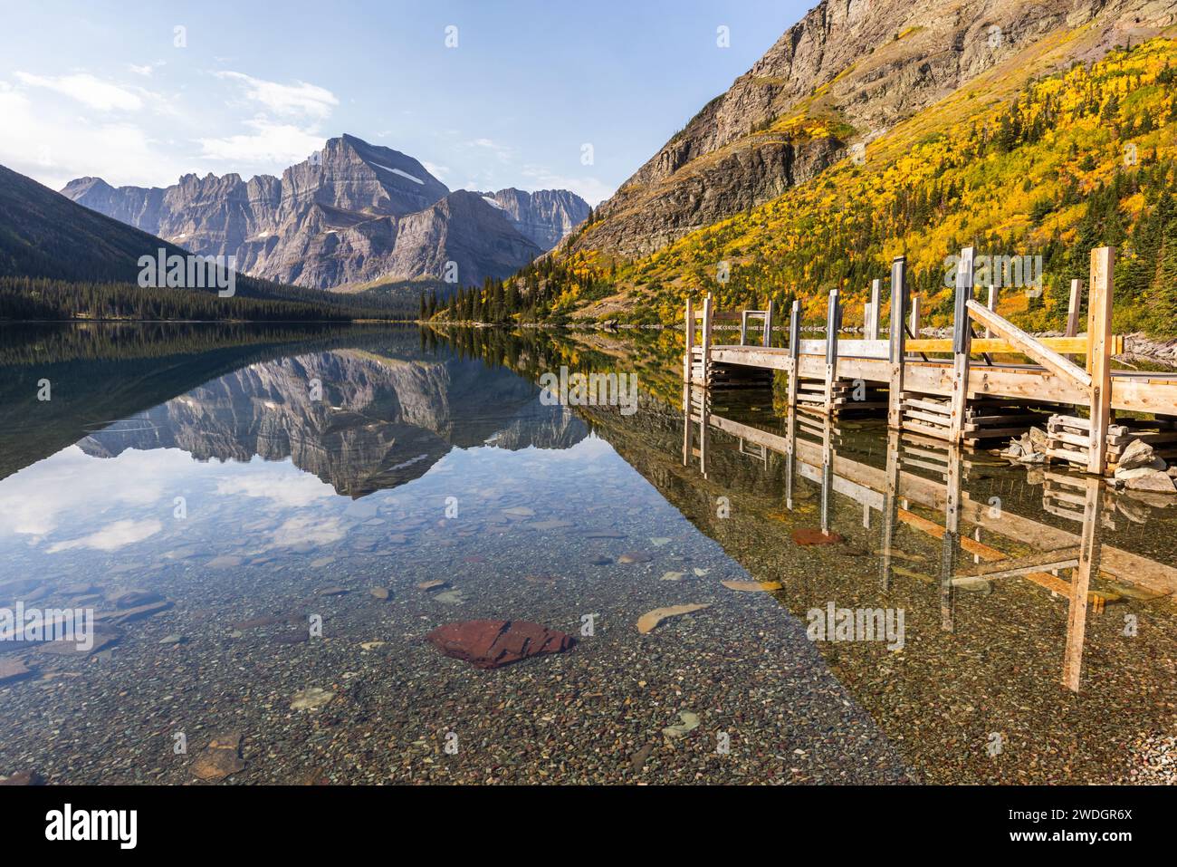 Lake Josephine reflecting the beautiful steep mountains of Glacier ...