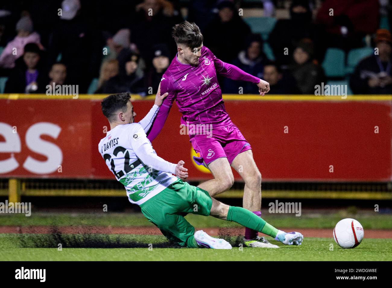 Barry, UK. 20th Jan, 2024. Danny Davies of TNS tackles Ben Lloyd of ...