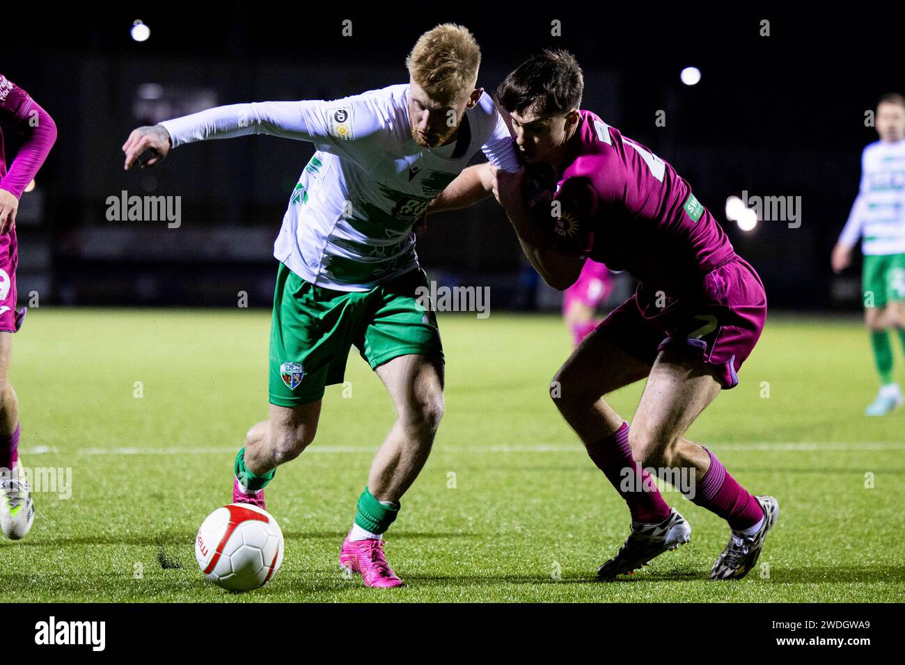 Barry, UK. 20th Jan, 2024. Brad Young of TNS in action against Kian ...