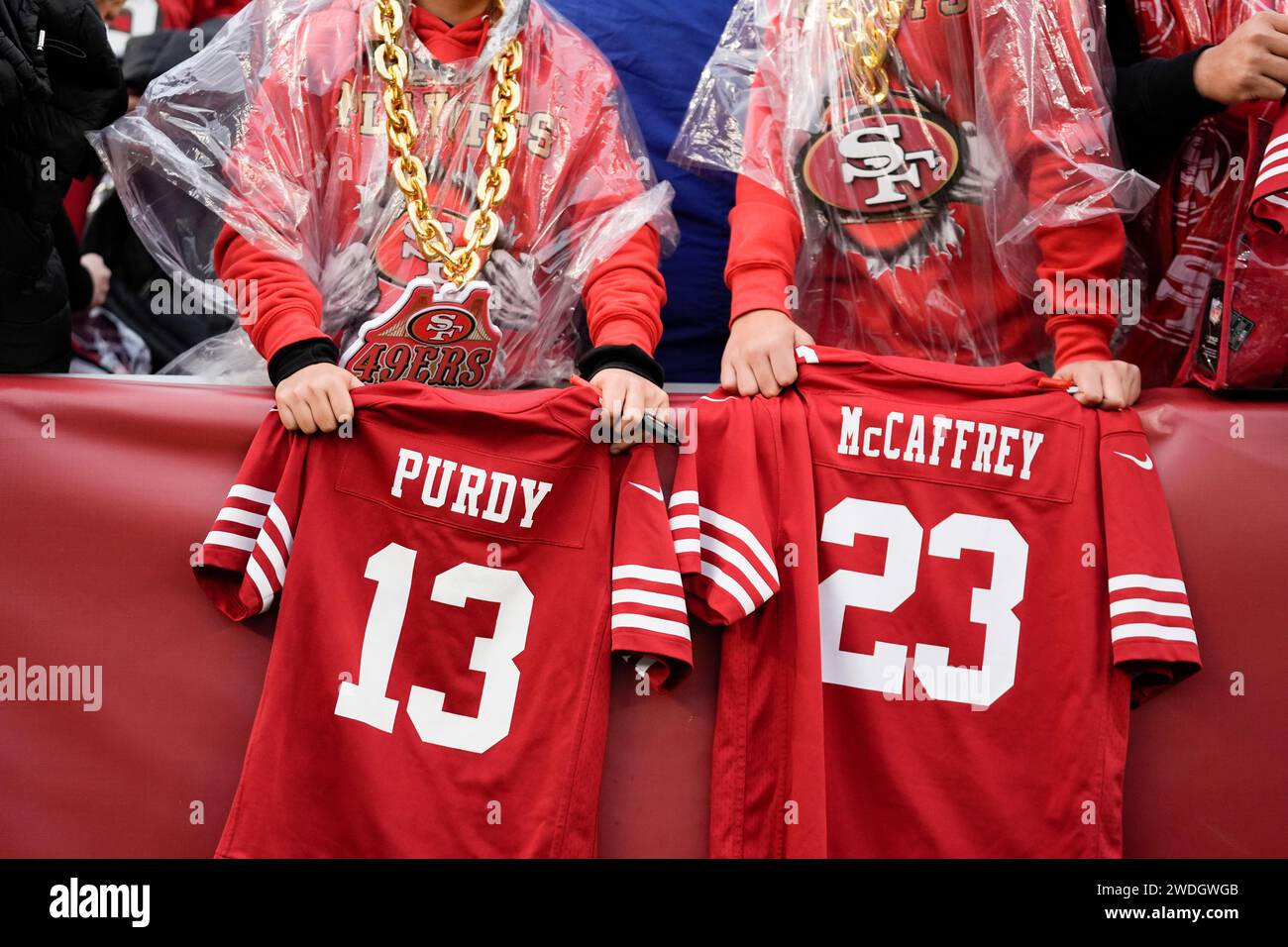 Fans hold San Francisco 49ers jerseys before an NFL football NFC ...