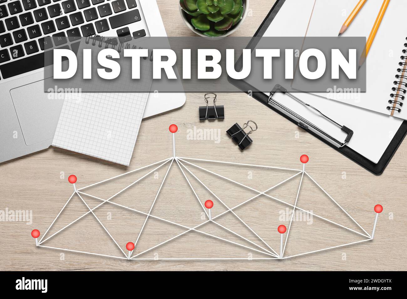 Distribution. Laptop and different stationery on wooden desk, flat lay ...
