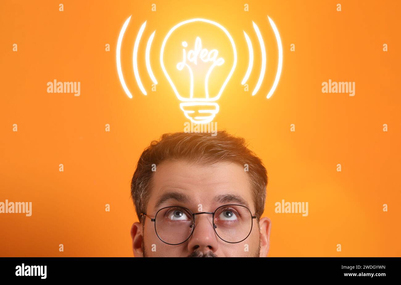 Idea generation. Man looking at illustration of glowing light bulb over ...