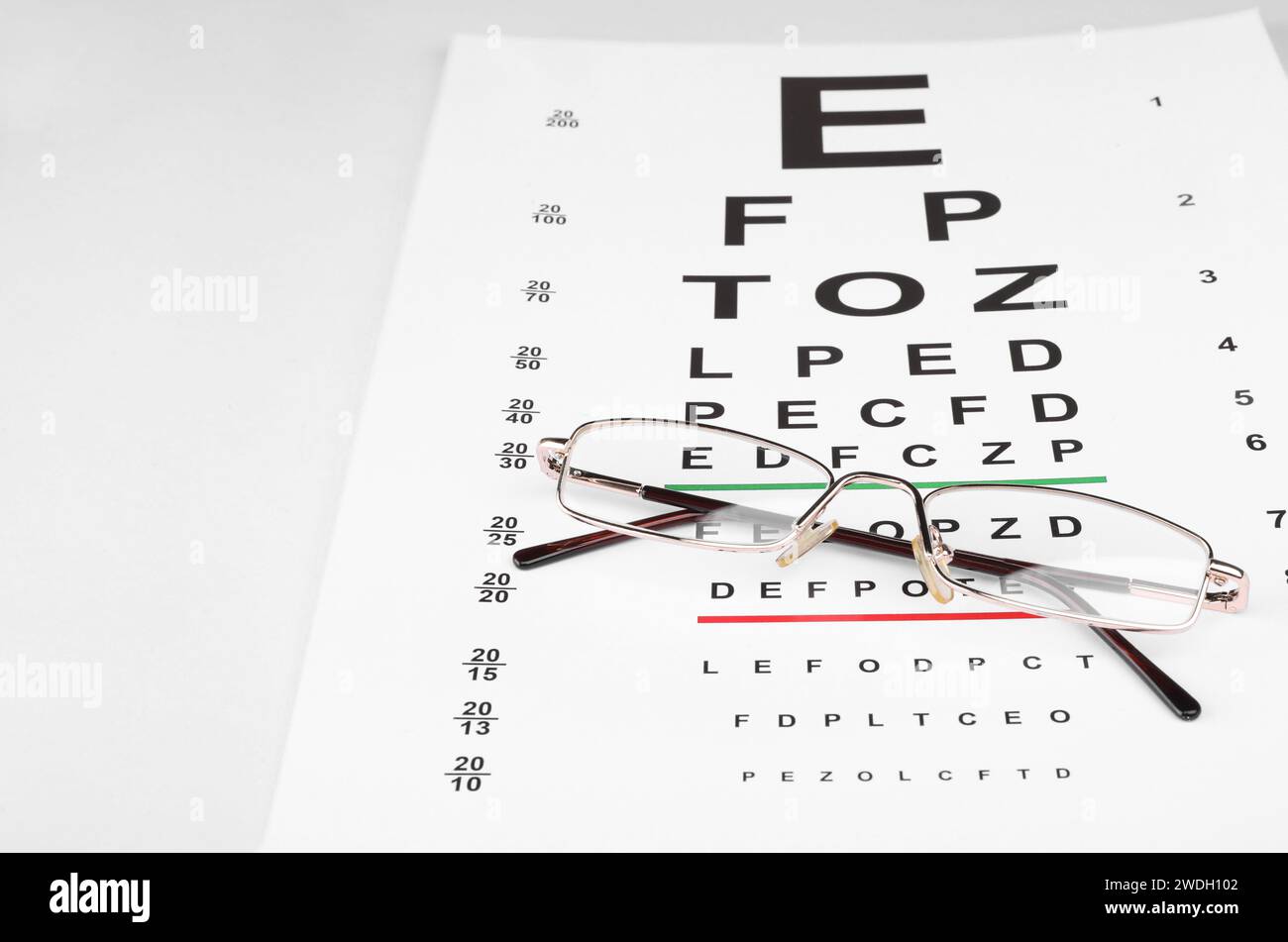 Glasses and vision test chart isolated on white Stock Photo - Alamy