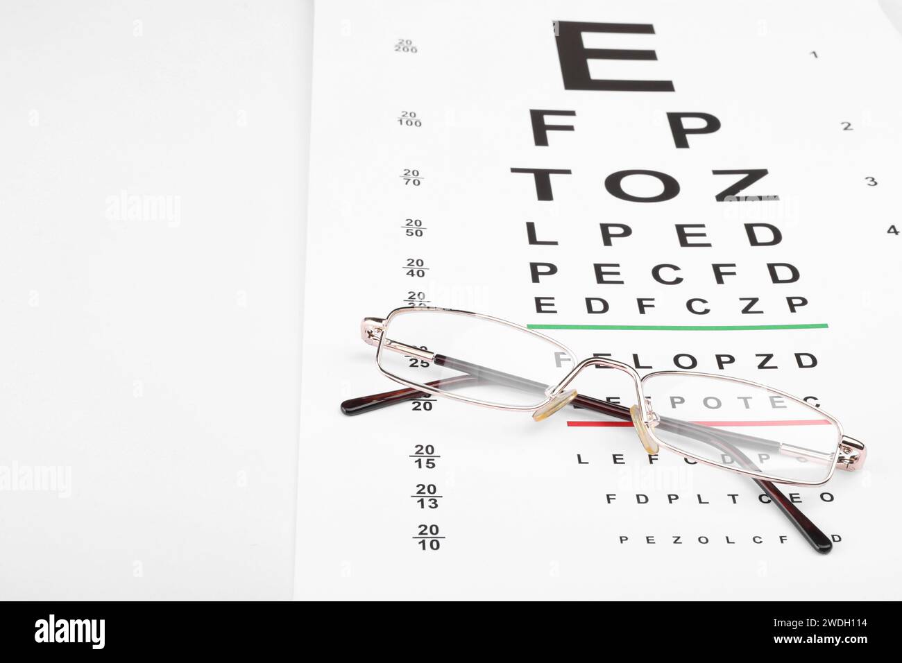 Glasses and vision test chart isolated on white Stock Photo - Alamy