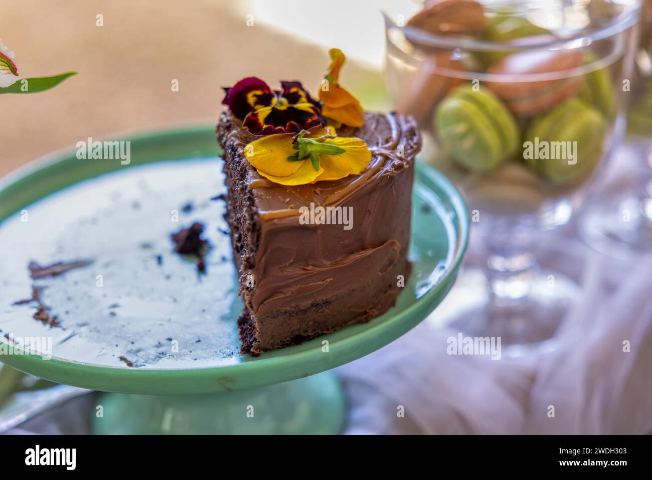 chocolate cake with flowers and macaroni in the display at the flea ...