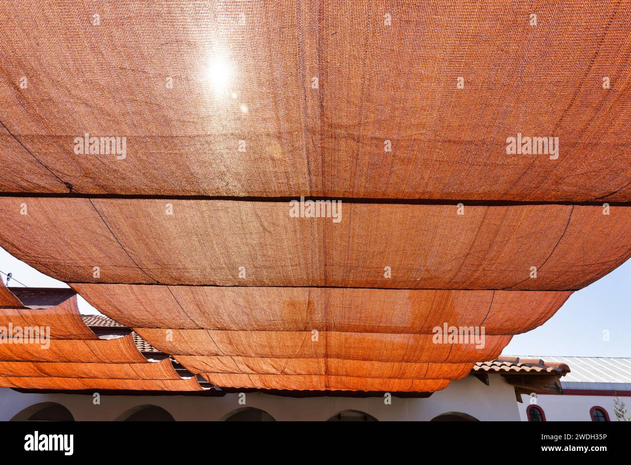 net shade protecting the building patio from the hot sun Stock Photo ...