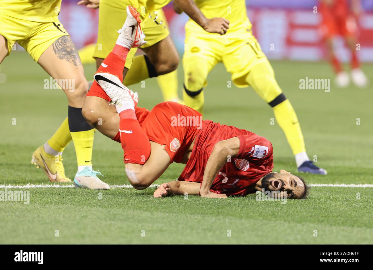 Doha, Qatar. 20th Jan, 2024. Ali Madan of Bahrain falls down during the ...