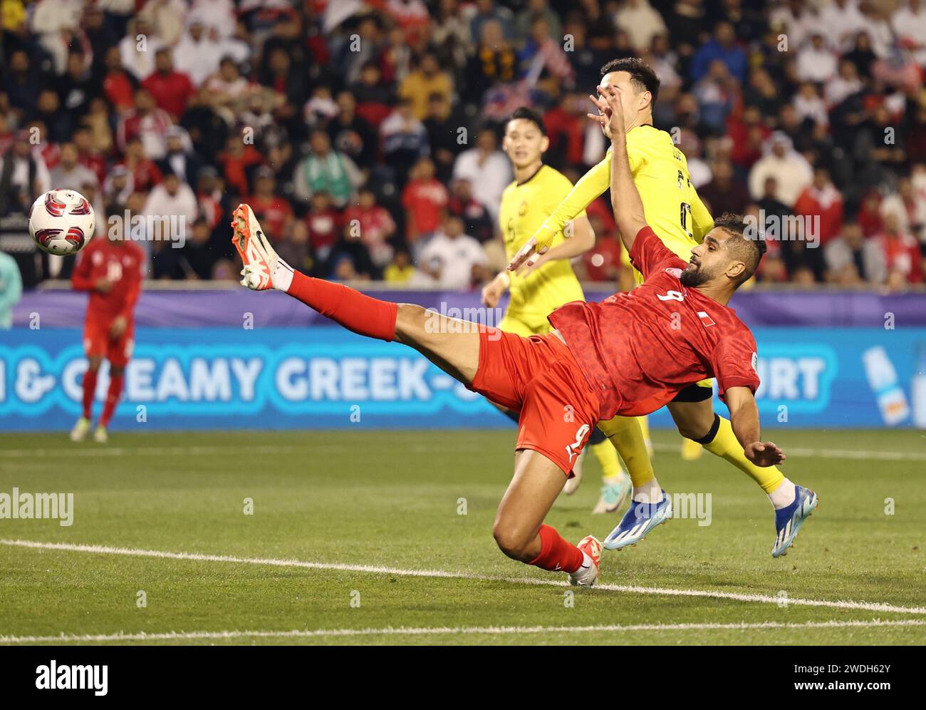 Doha, Qatar. 20th Jan, 2024. Abdulla Yusuf (front) of Bahrain shoots ...