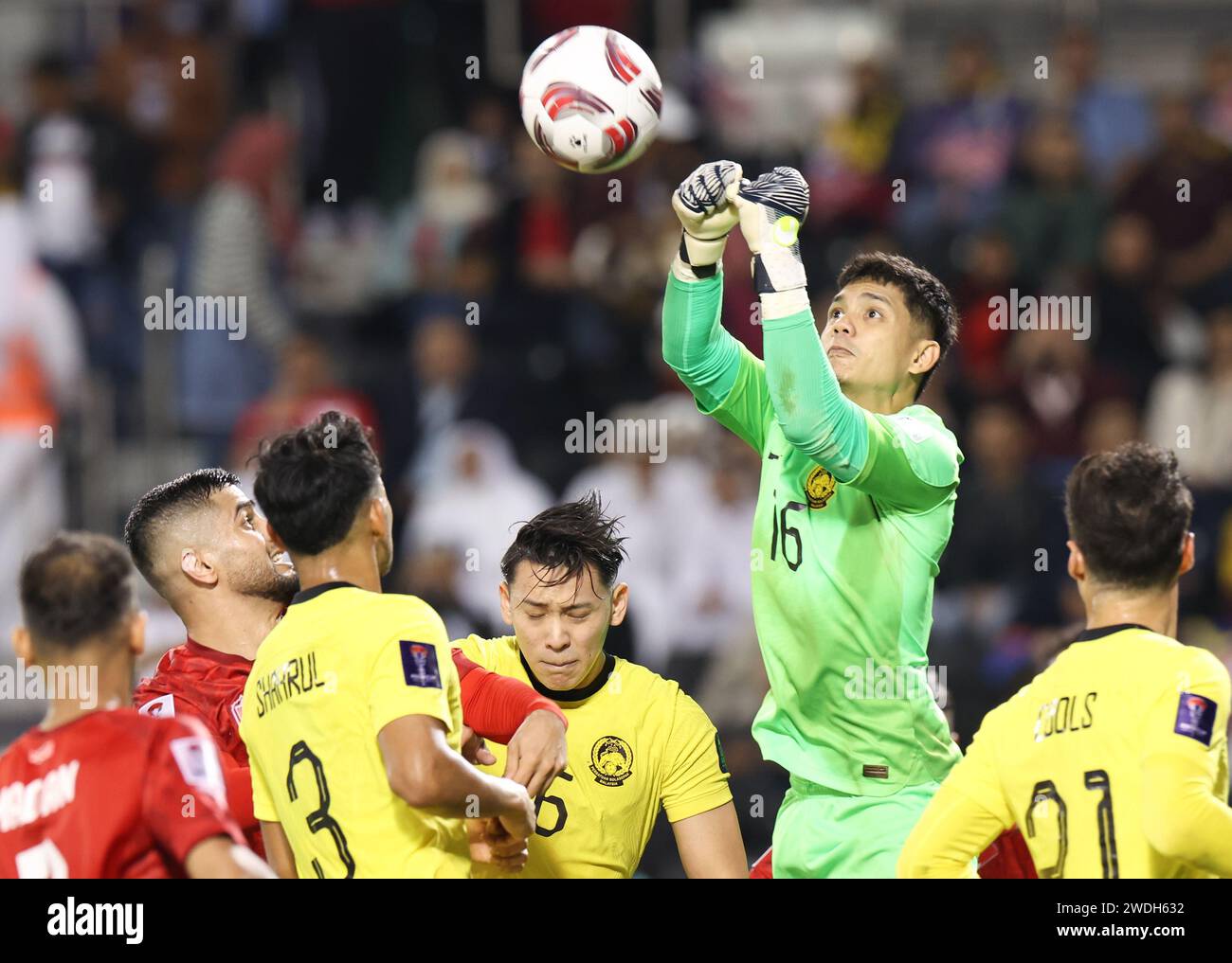 Doha, Qatar. 20th Jan, 2024. Ahmad Syihan Hazmi (top), goalkeeper of ...
