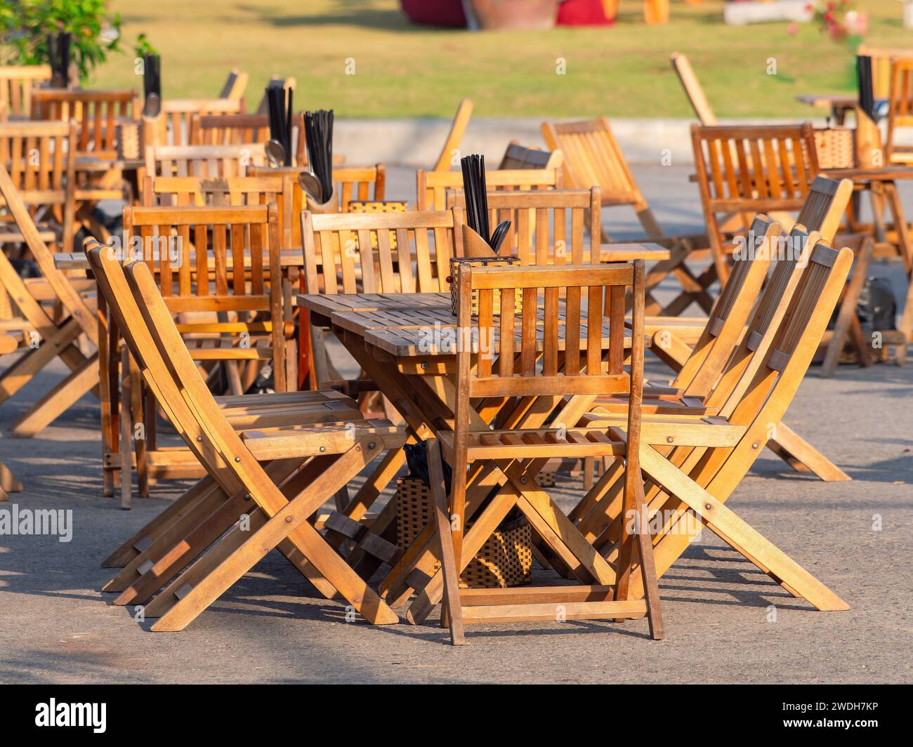 Teak furniture at an empty outdoor restaurant at a summer resort in ...