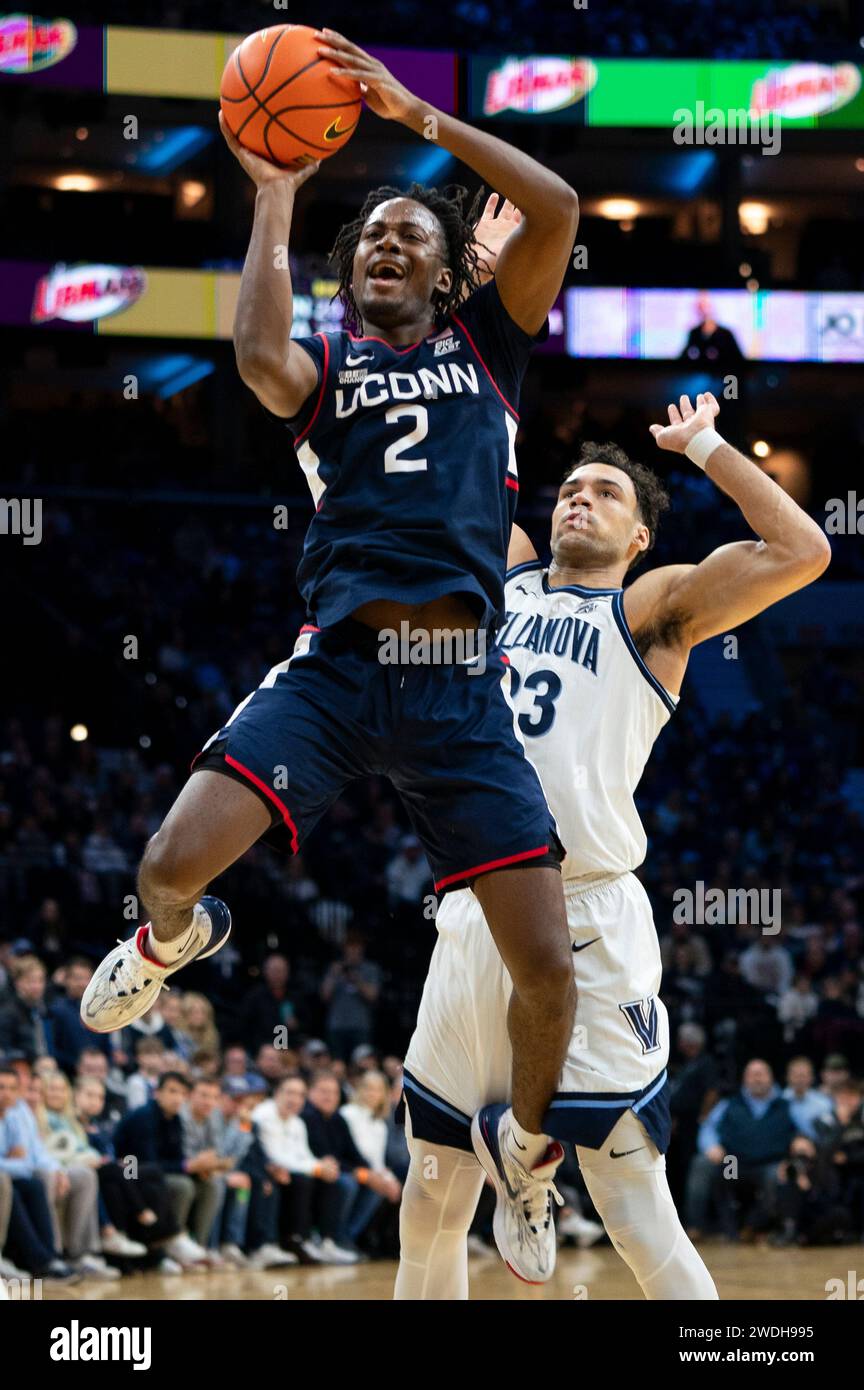 UConn's Tristen Newton, left, shoots while being fouled by Villanova's ...