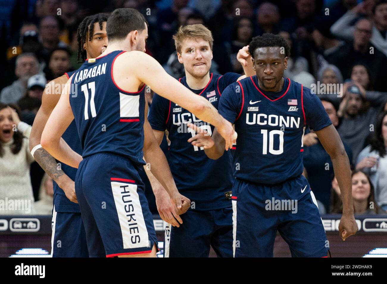 UConn's Hassan Diarra, right, celebrates with his teammates after ...