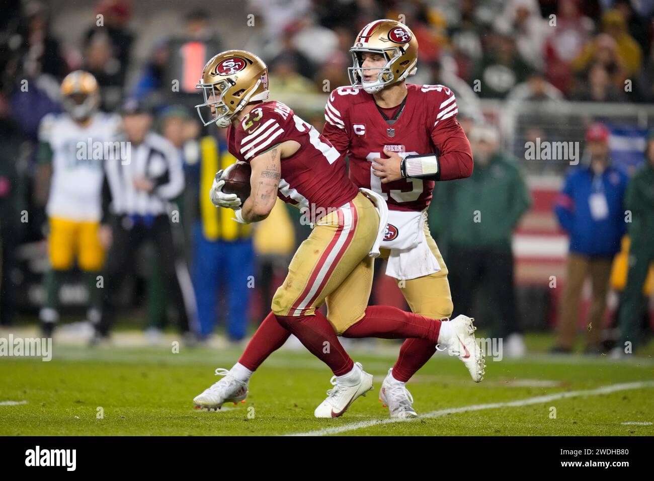 San Francisco 49ers running back Christian McCaffrey (23) takes a handoff from quarterback Brock ...