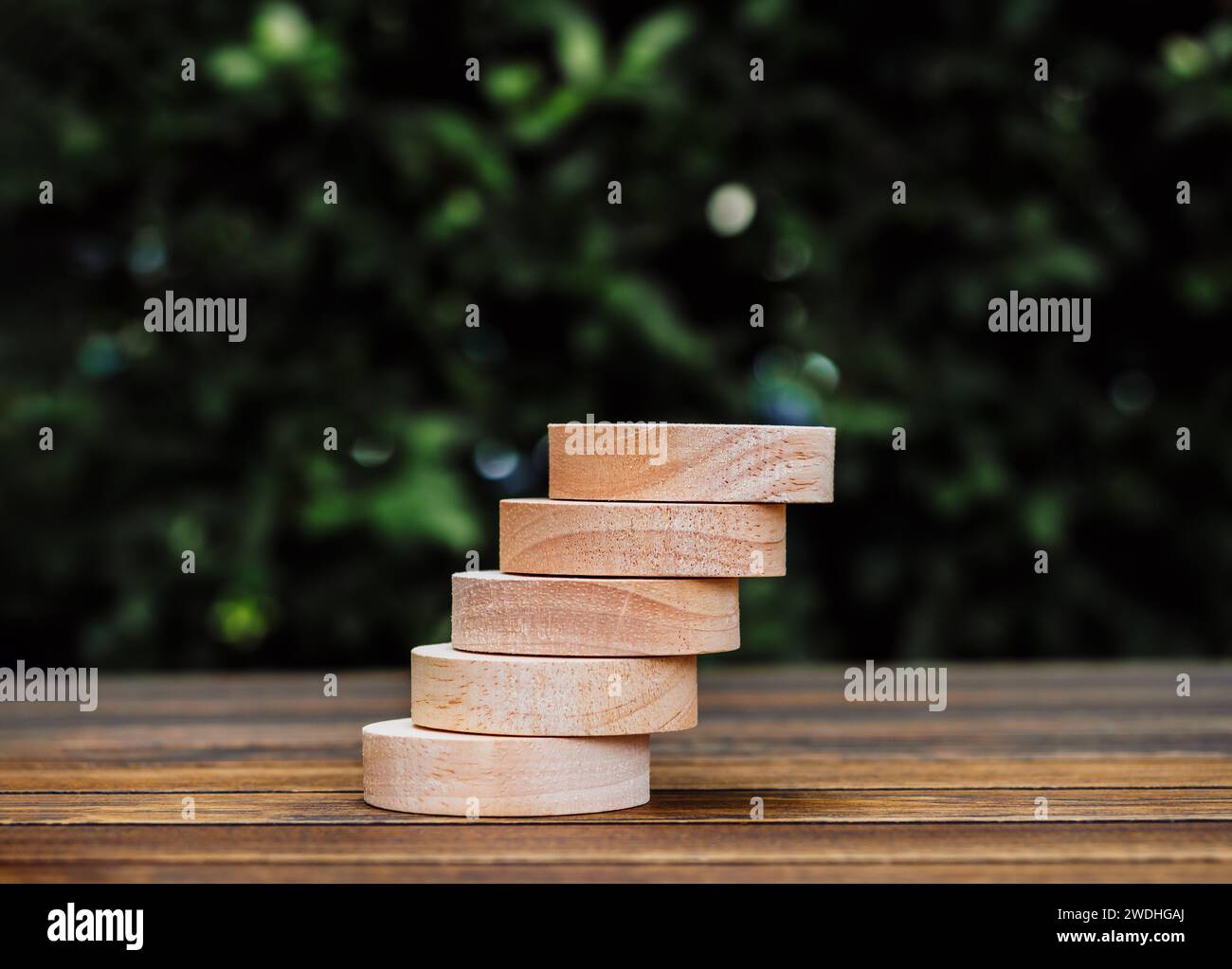 Blank round wooden blocks as a graph chart steps on wood table on green ...