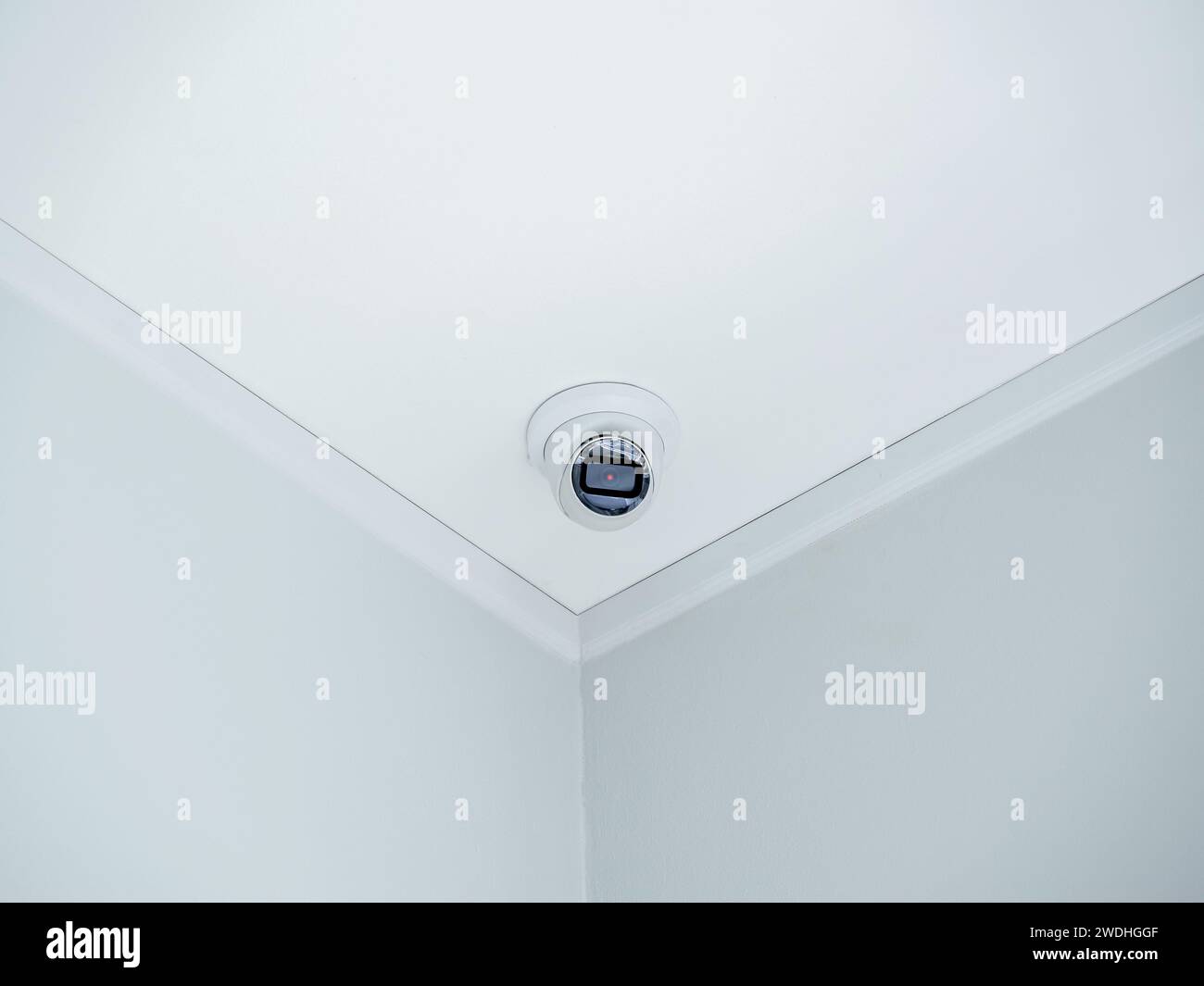 Digital security eye. A white round indoor CCTV surveillance camera ...