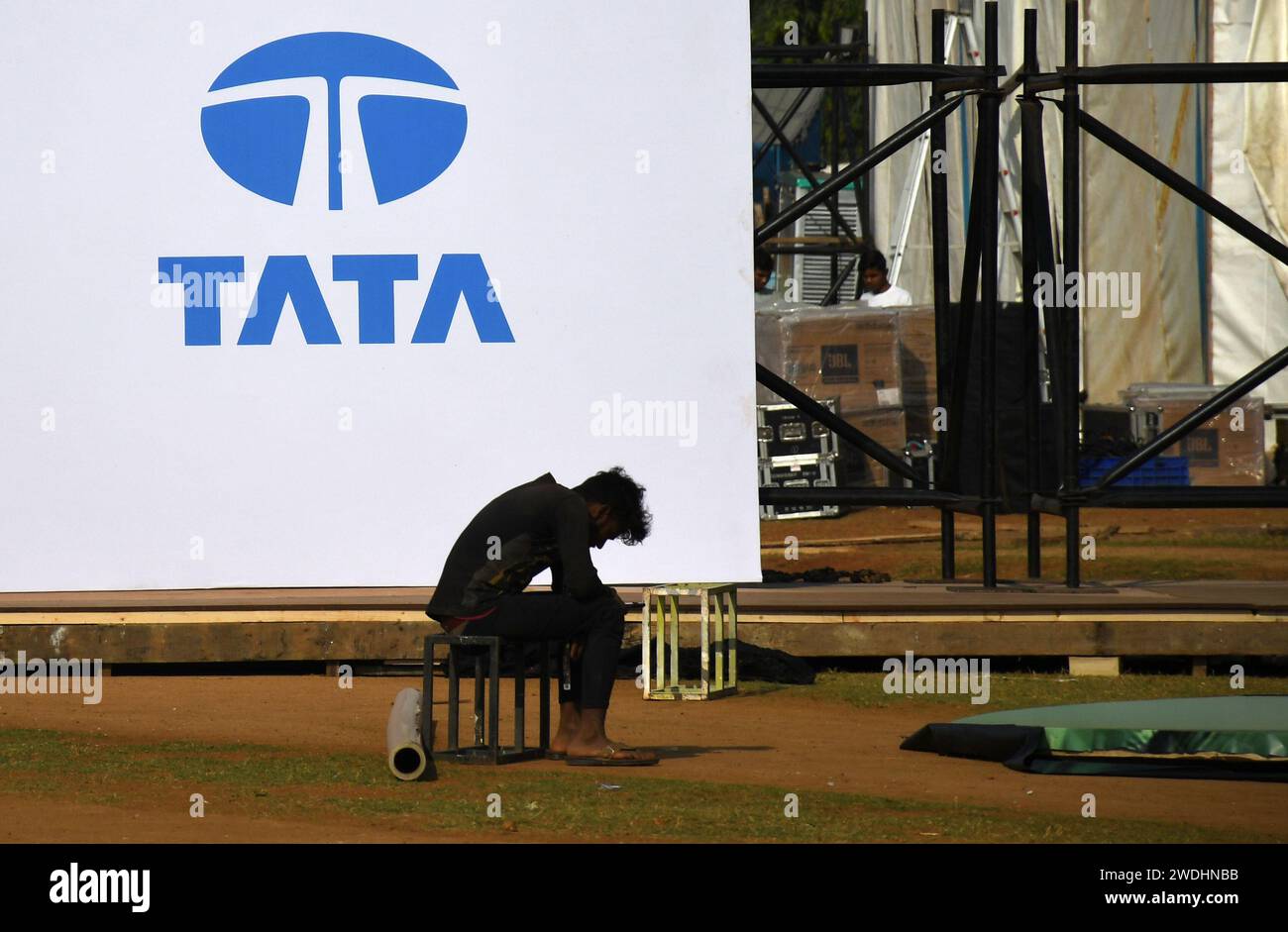 Mumbai, India. 20th Jan, 2024. A man seen sitting near a Tata logo in ...