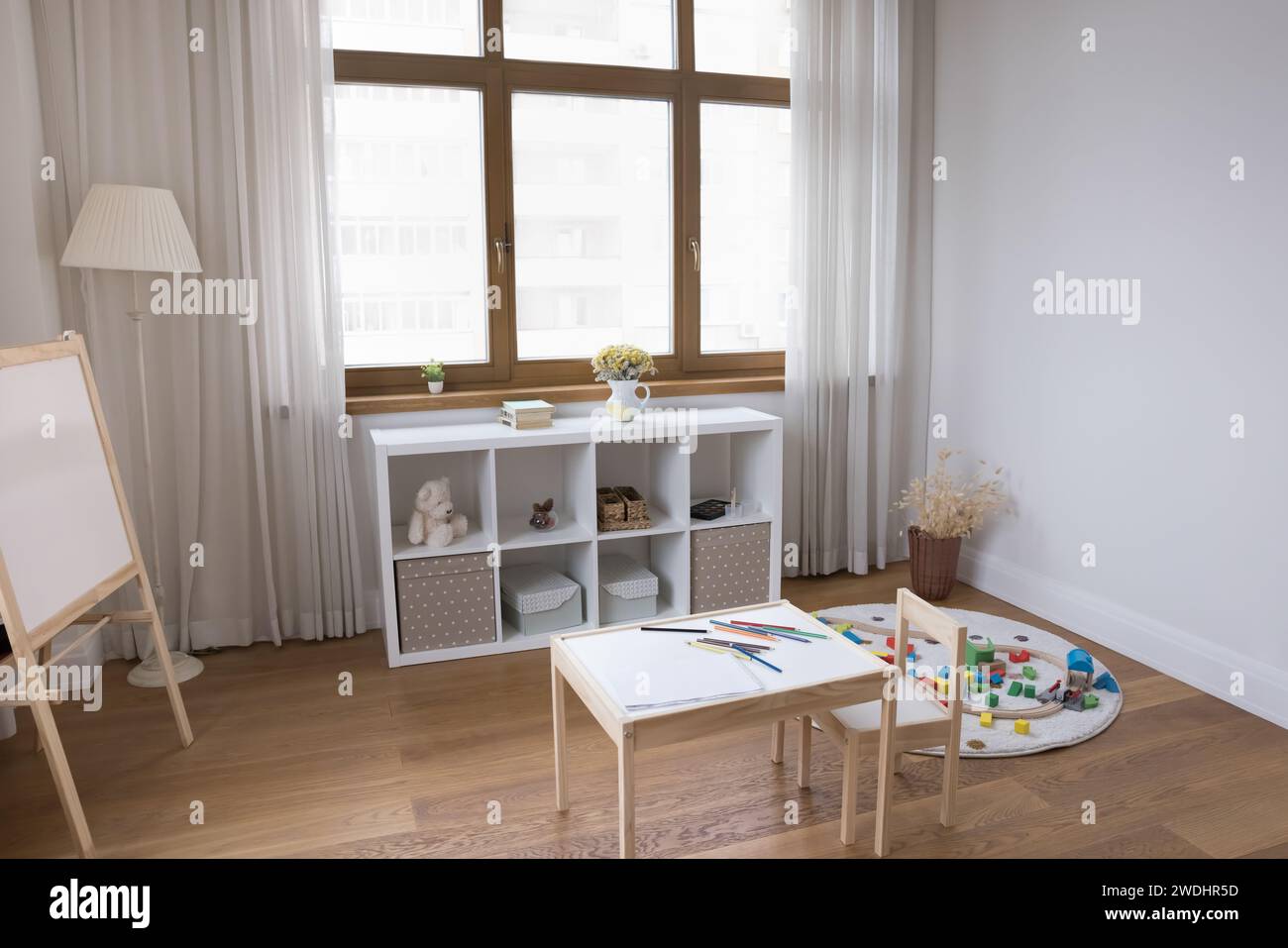 Cozy playroom with diverse toys and modern furniture Stock Photo - Alamy