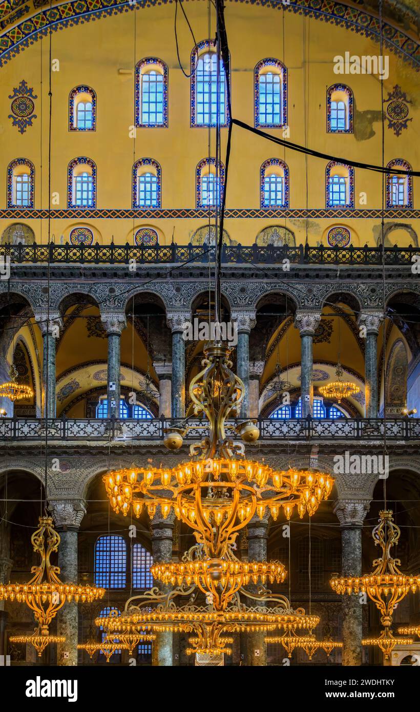 Istanbul, Turkey - November 8, 2023: Ornate arches and golden chandeliers inside the Hagia ...