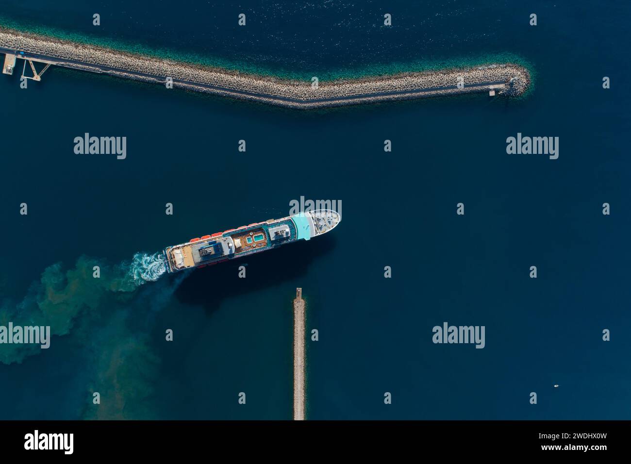 Aerial view of luxury medium cruise ship sailing from port. top view ...