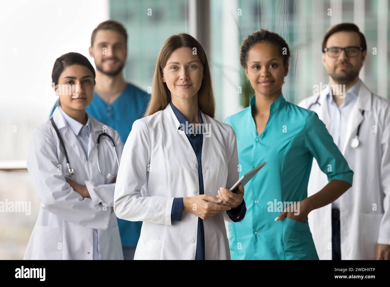 Happy positive young female head doctor posing for professional ...